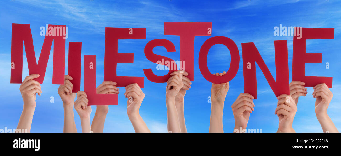 People Hands Holding Red Word Milestone Blue Sky Stock Photo - Alamy