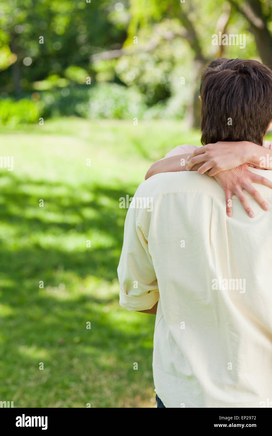 Man with his friends arms holding the back of his neck Stock Photo - Alamy