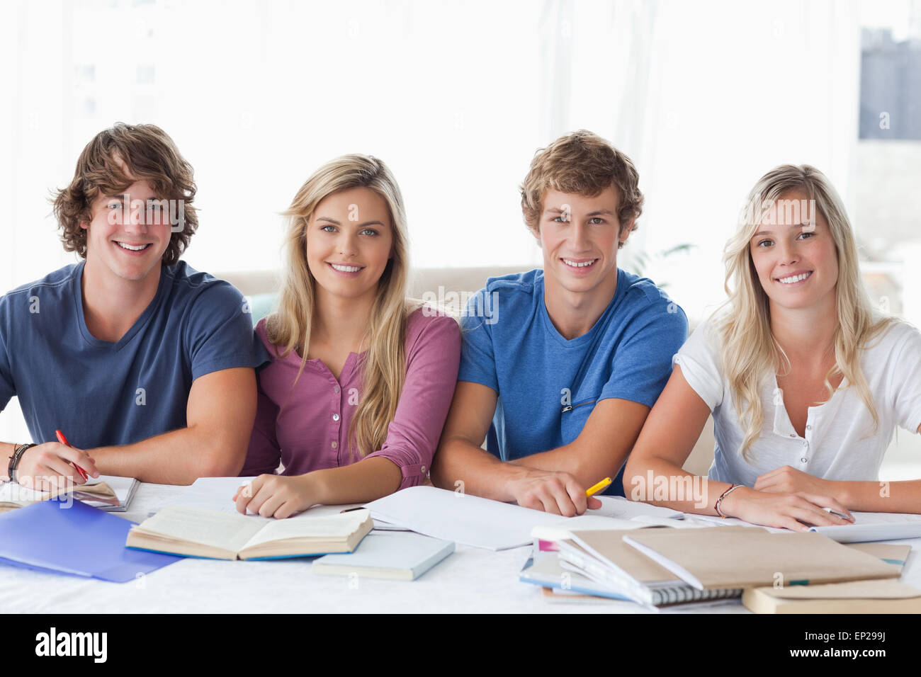 A smiling group of student sitting and looking at the camera Stock ...