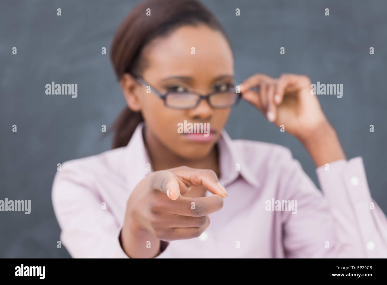Focus on a strict black teacher pointing finger Stock Photo - Alamy
