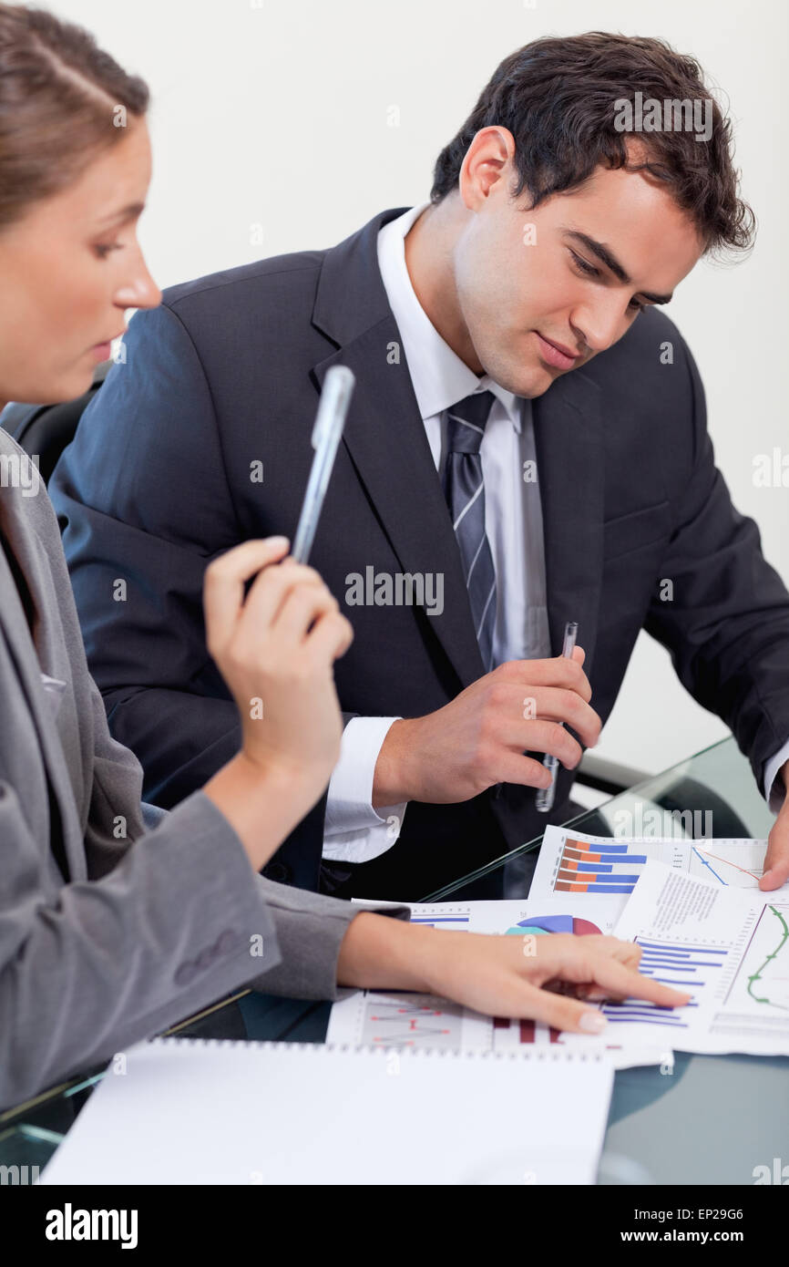 Portrait of a concentrated business team studying statistics Stock ...