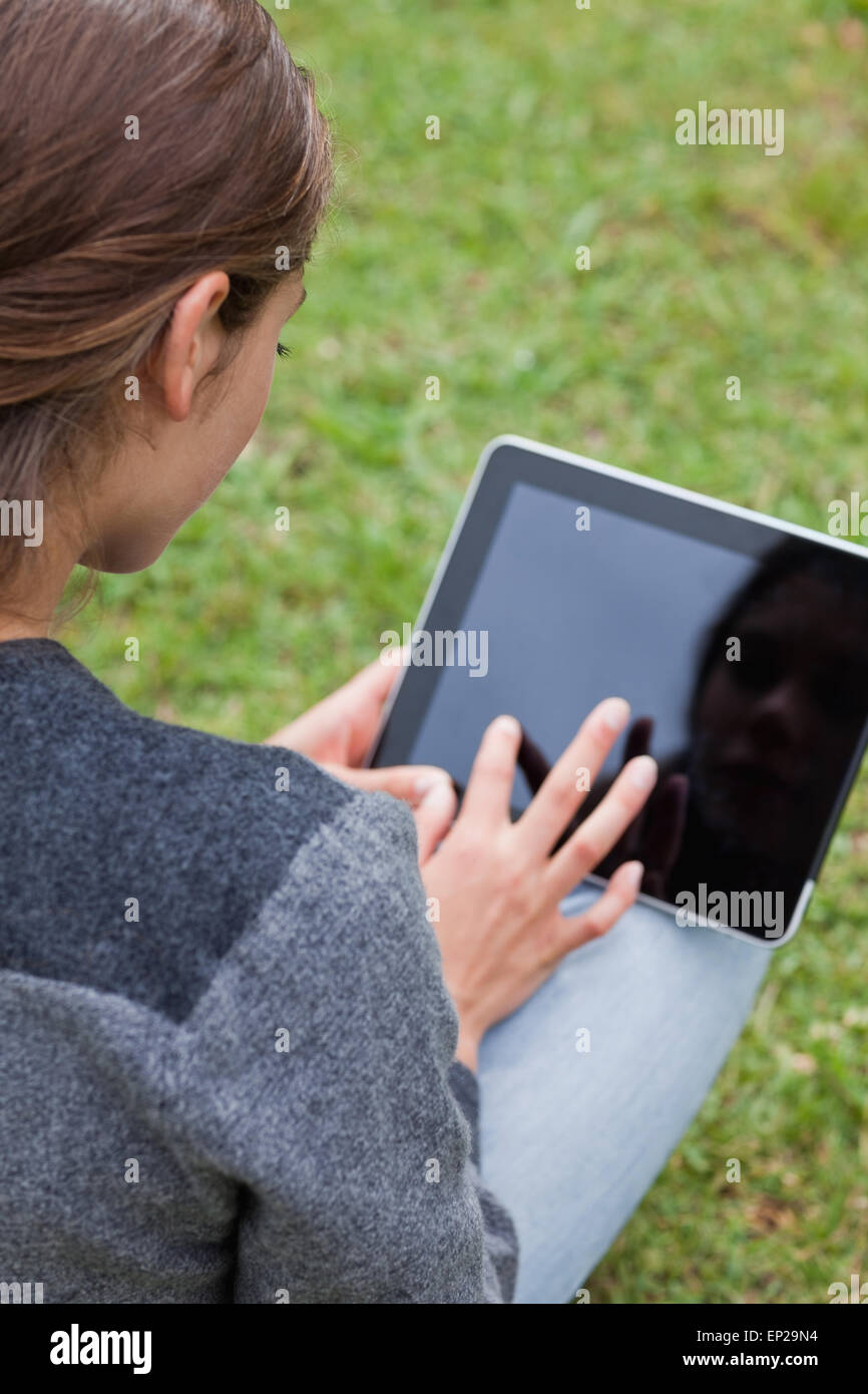Rear view of a young girl using her tablet pc Stock Photo - Alamy