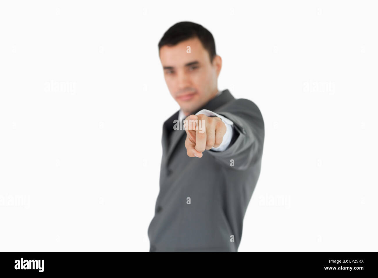 Side view of businessman pointing towards camera Stock Photo - Alamy