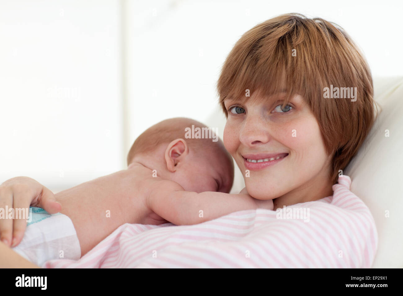 Mother embracing her newborn baby Stock Photo - Alamy