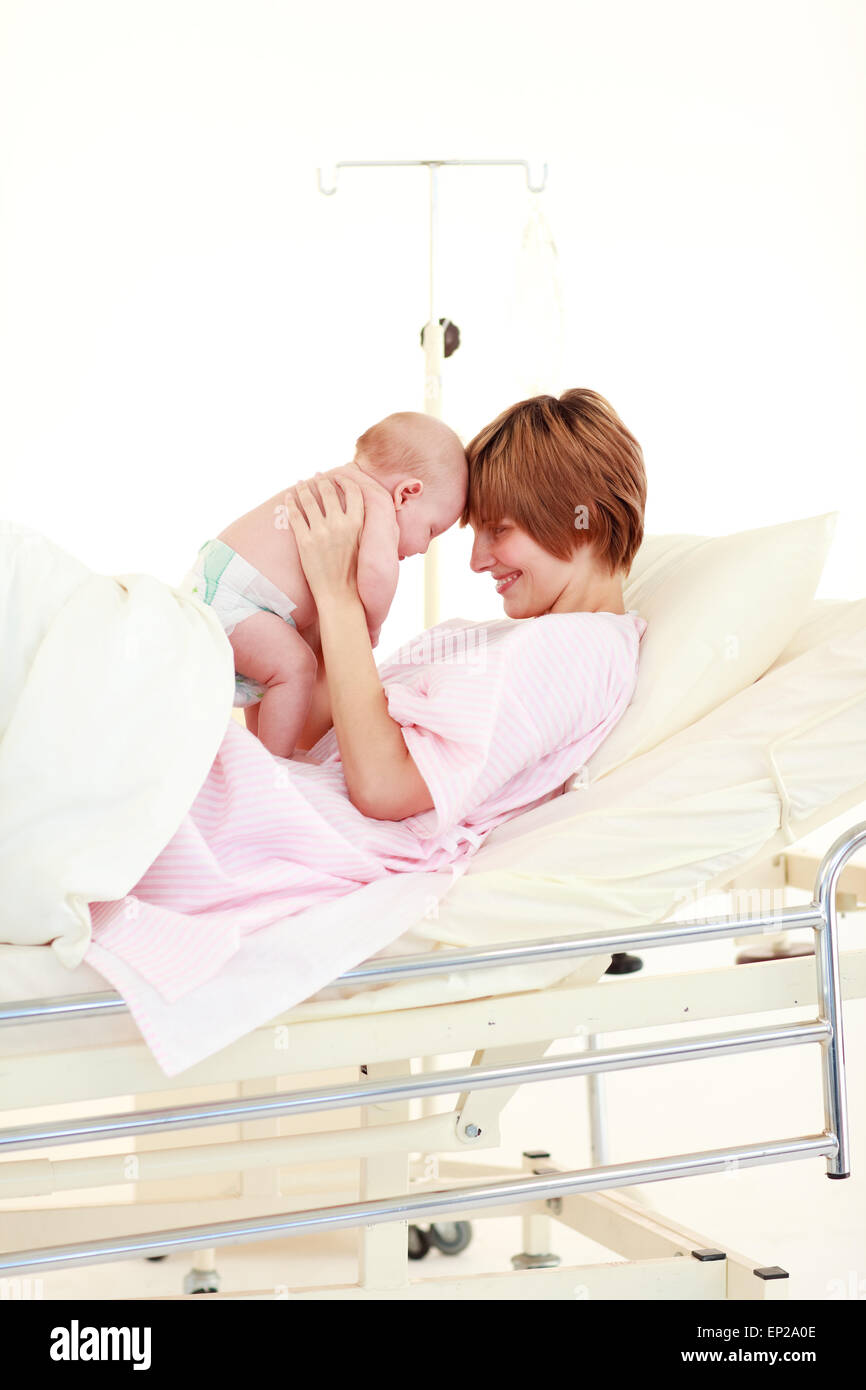 Mother embracing her newborn baby Stock Photo - Alamy