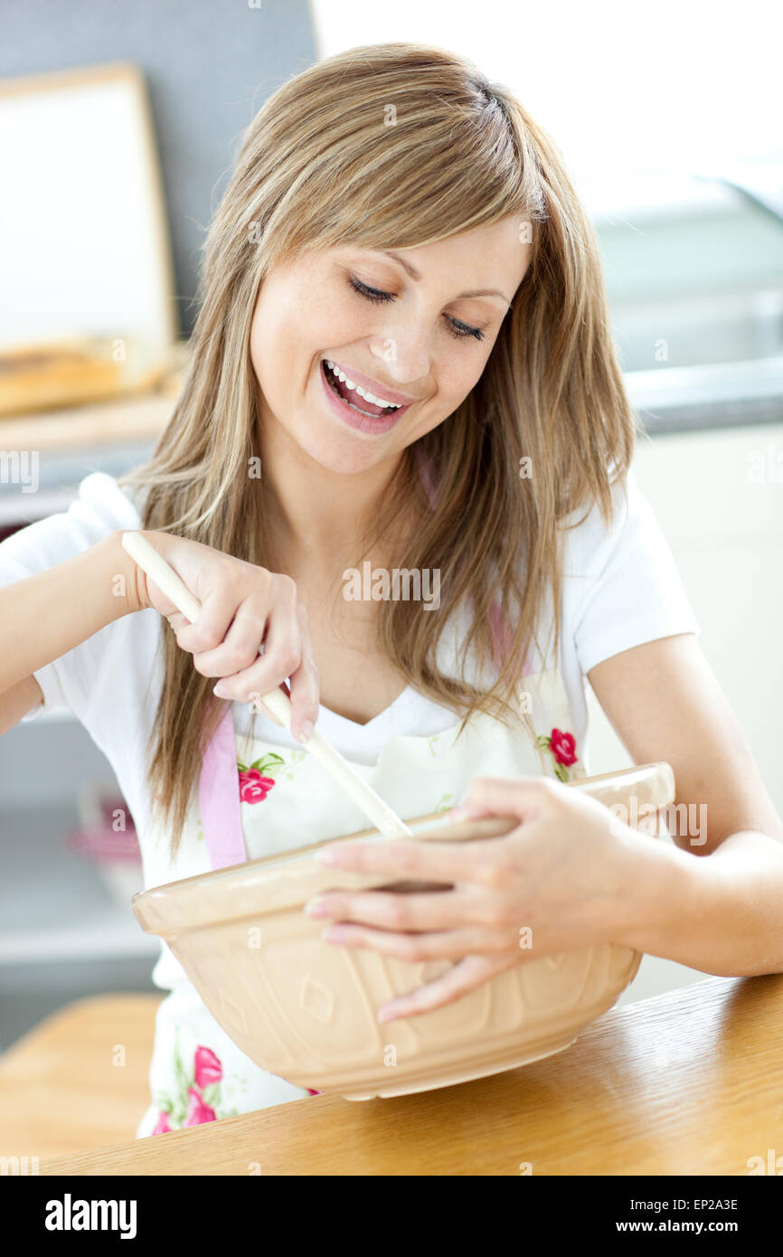 Caucasian woman preparing a cake in the kitchen Stock Photo - Alamy