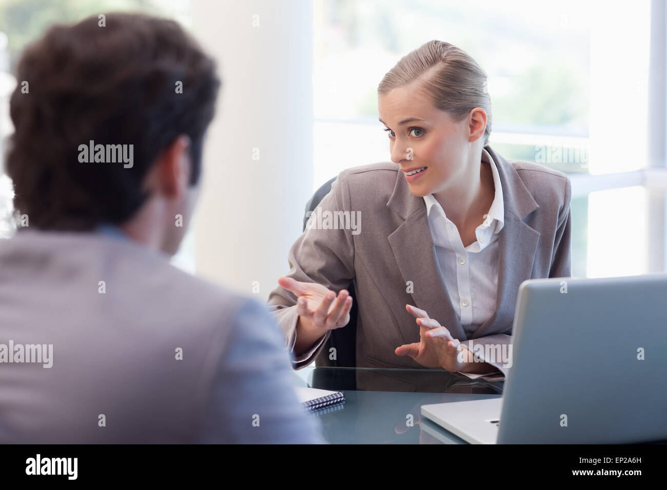 Cute businesswoman receiving a customer Stock Photo - Alamy