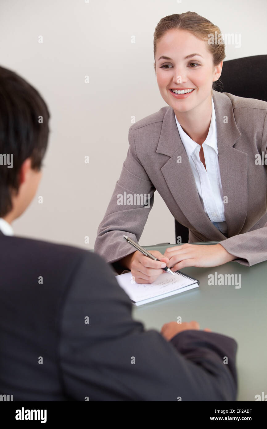 Portrait of a smiling manager interviewing a male applicant Stock Photo ...