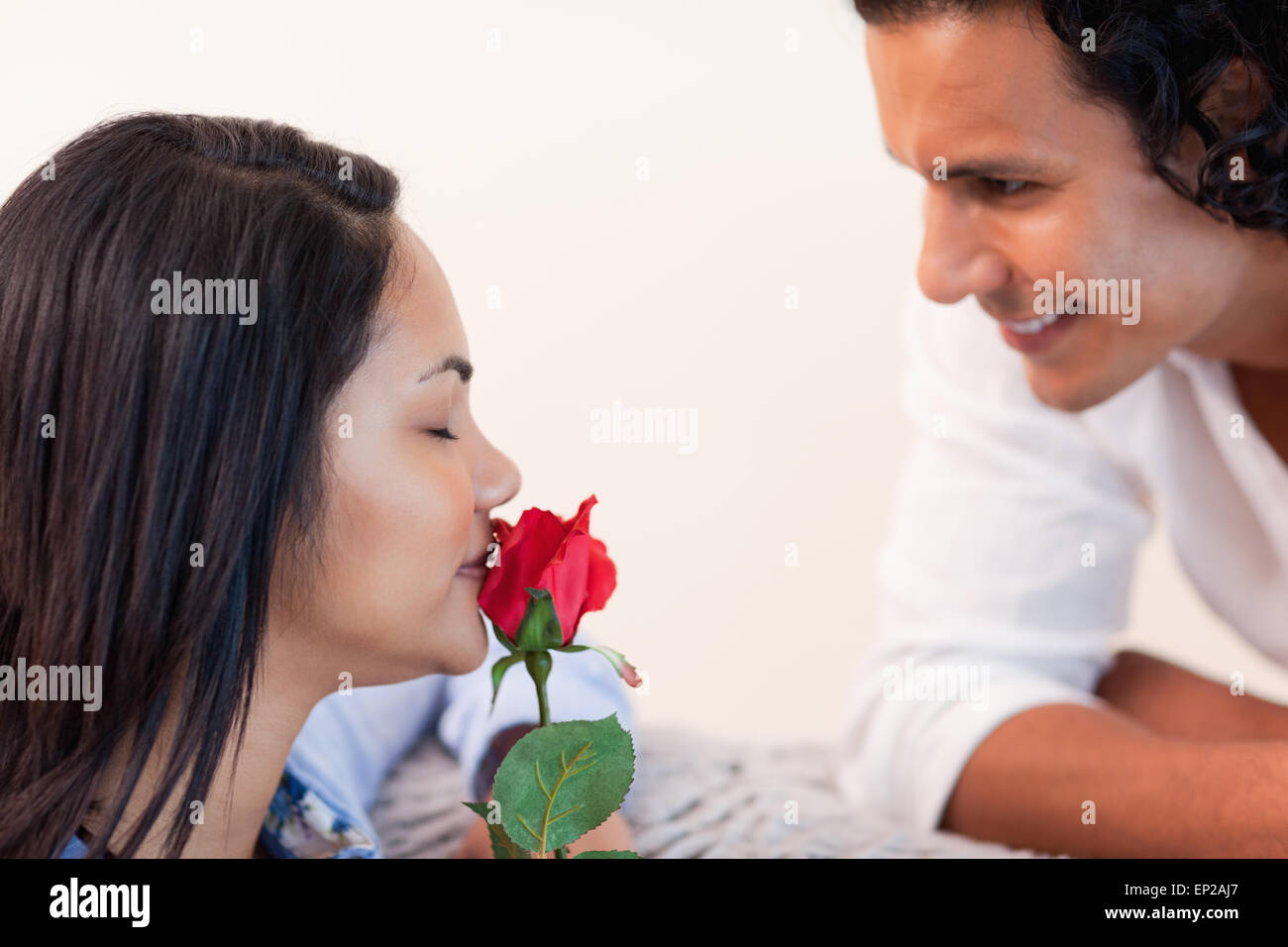 Man giving his girlfriend a rose for valentines day Stock Photo - Alamy