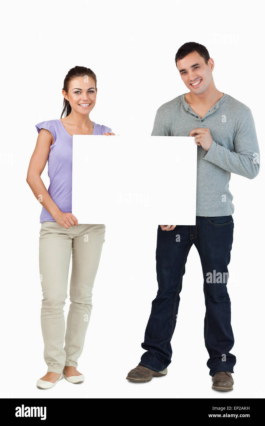 Young couple holding sign Stock Photo - Alamy