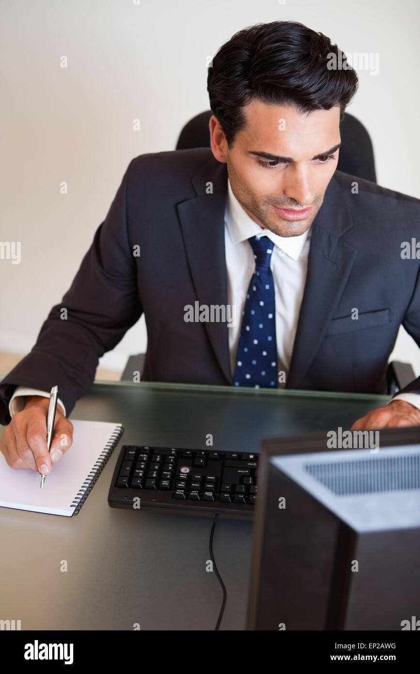 Portrait of a focused businessman taking notes Stock Photo - Alamy