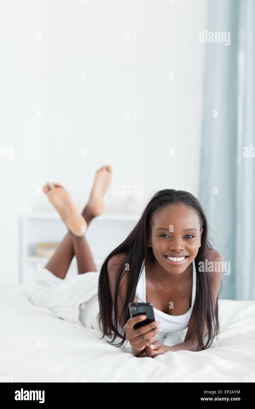 Portrait of a young woman sending text messages Stock Photo - Alamy