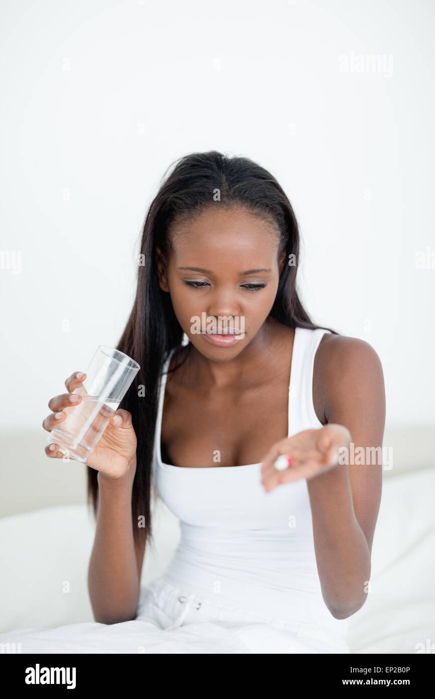 Portrait of a sick looking at pills Stock Photo - Alamy