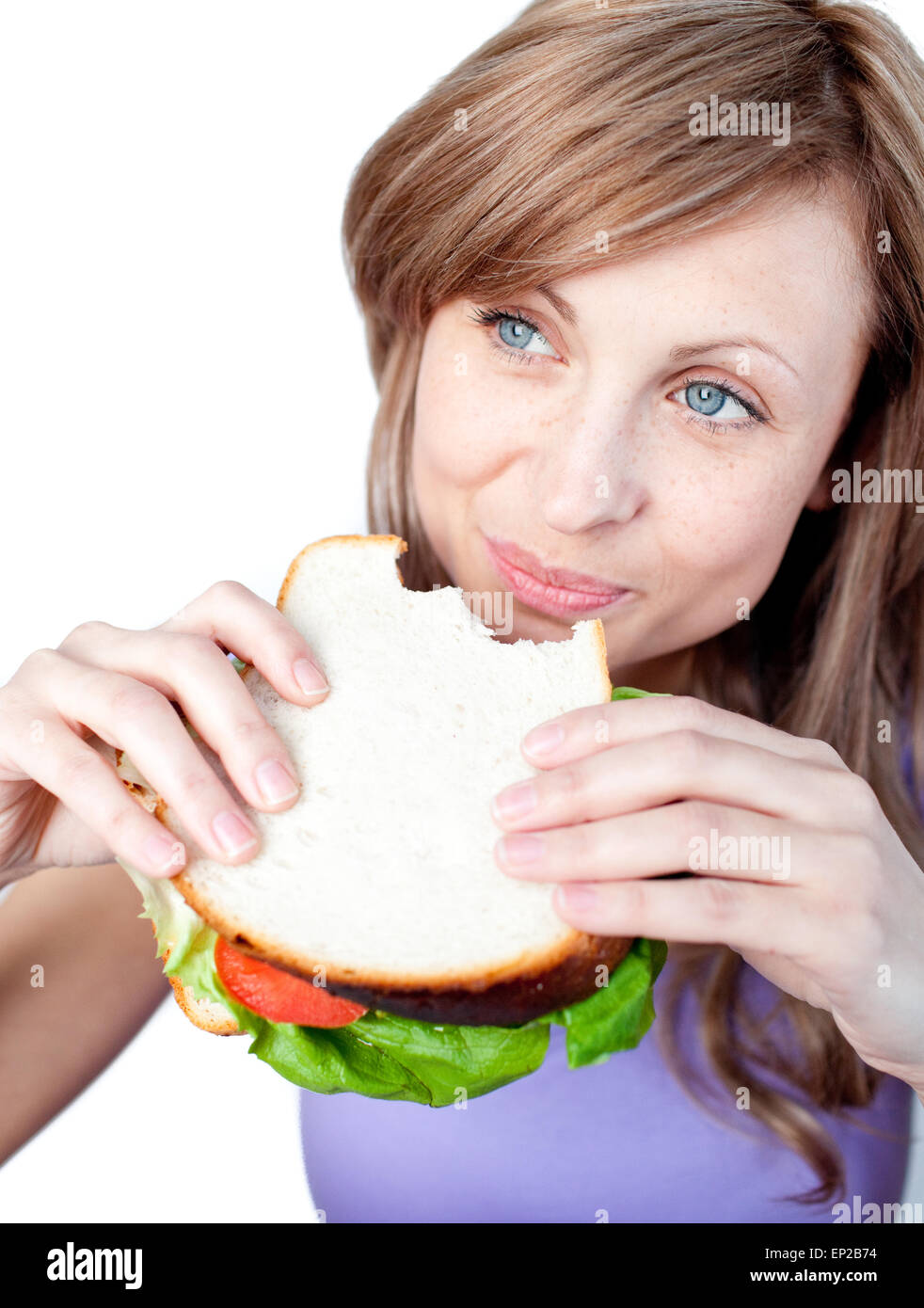 Cheerful woman eating a sandwich Stock Photo - Alamy