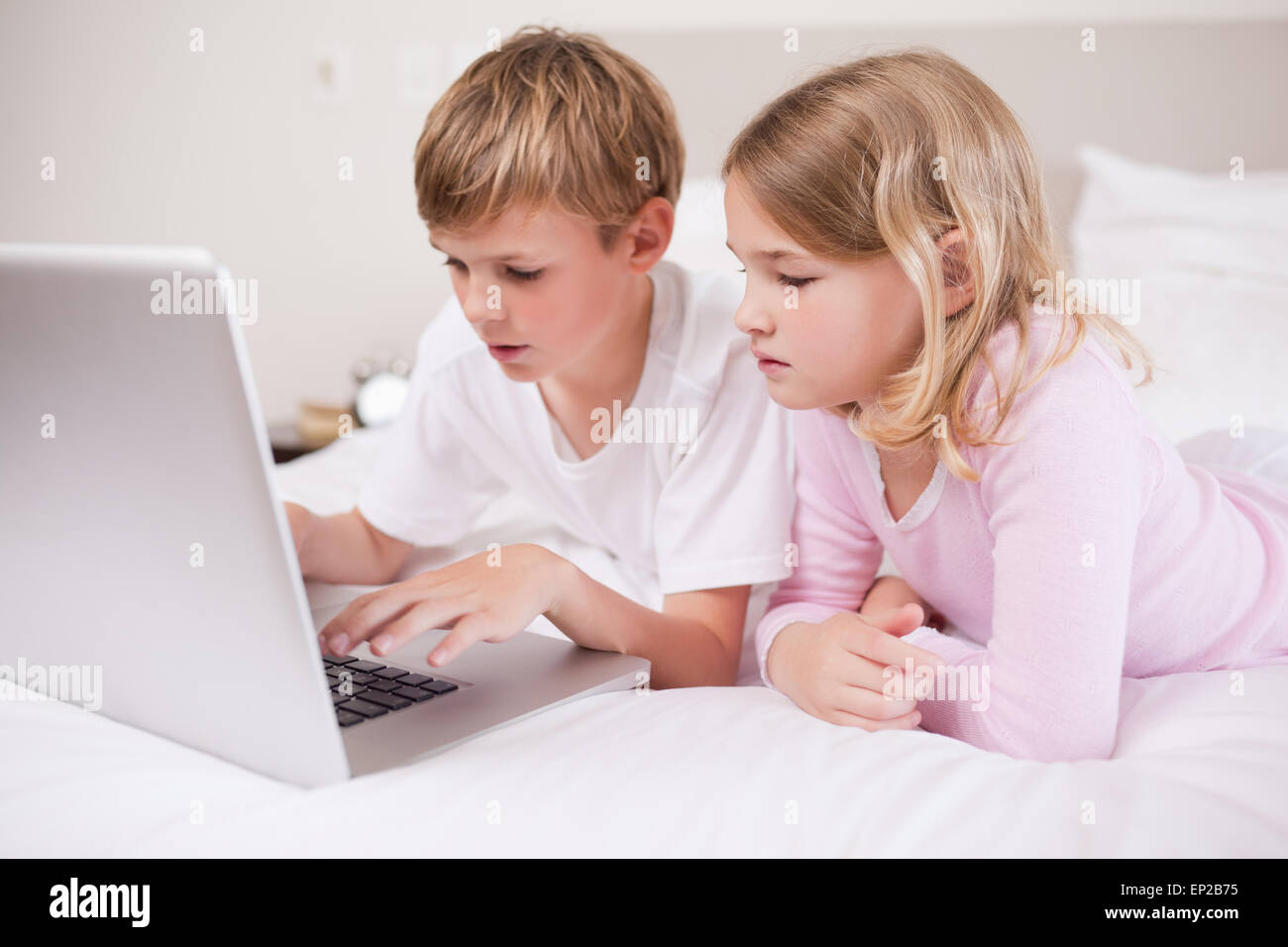 Cute children using a laptop Stock Photo - Alamy