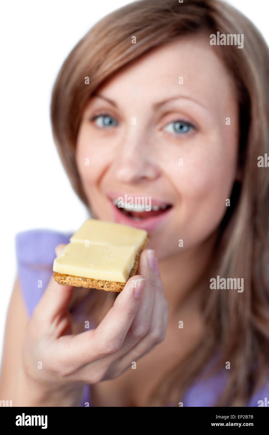Charming woman eating a cracker with cheese Stock Photo - Alamy