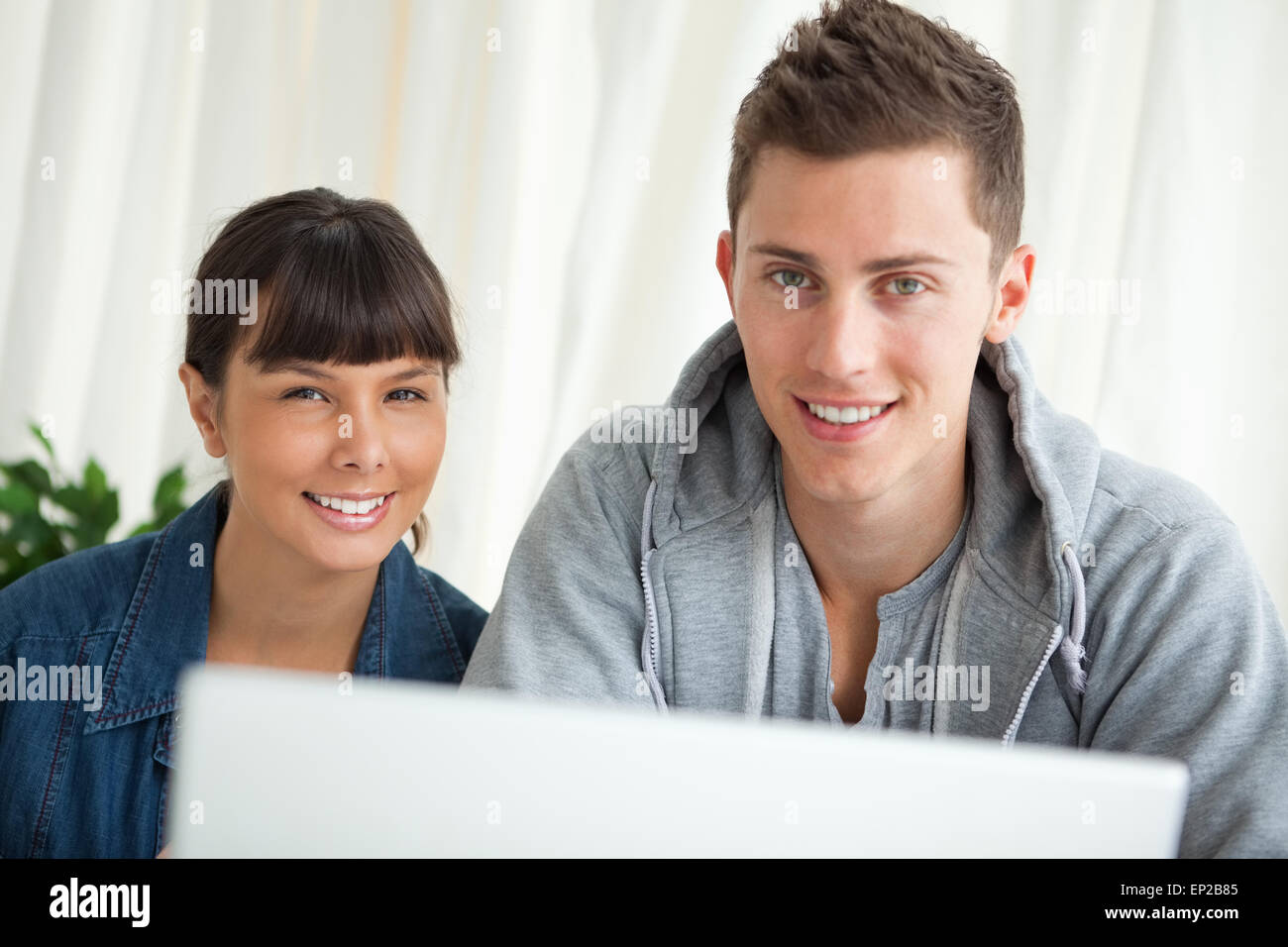 Portrait of two smiling students working together Stock Photo - Alamy