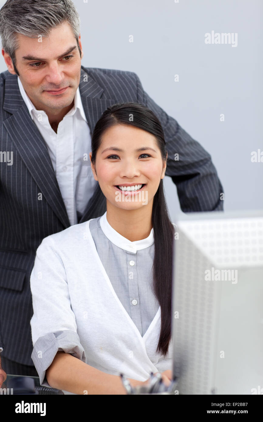Laughing businesswoman helping by her manager Stock Photo - Alamy