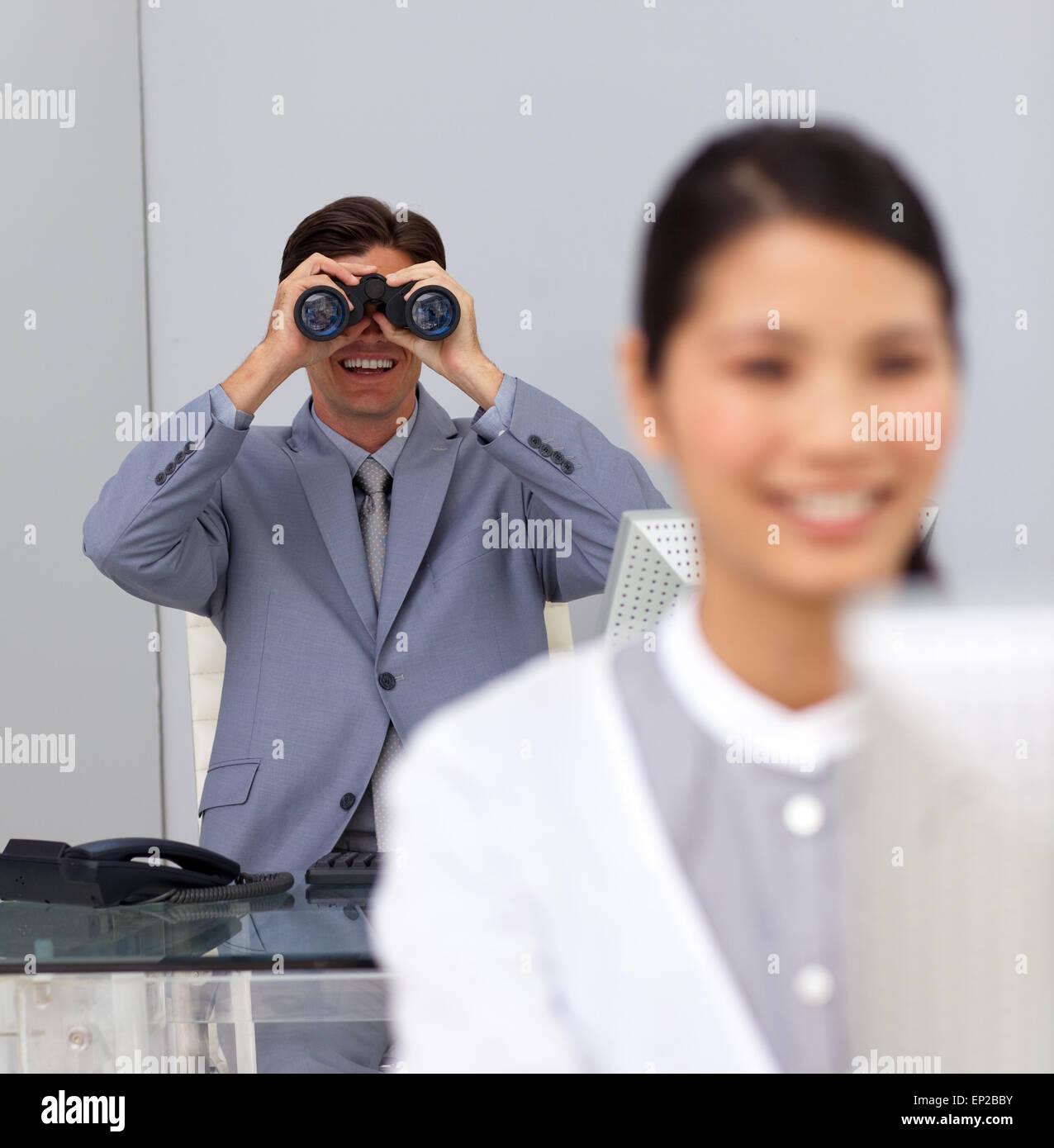 Smiling businessman using binoculars Stock Photo - Alamy