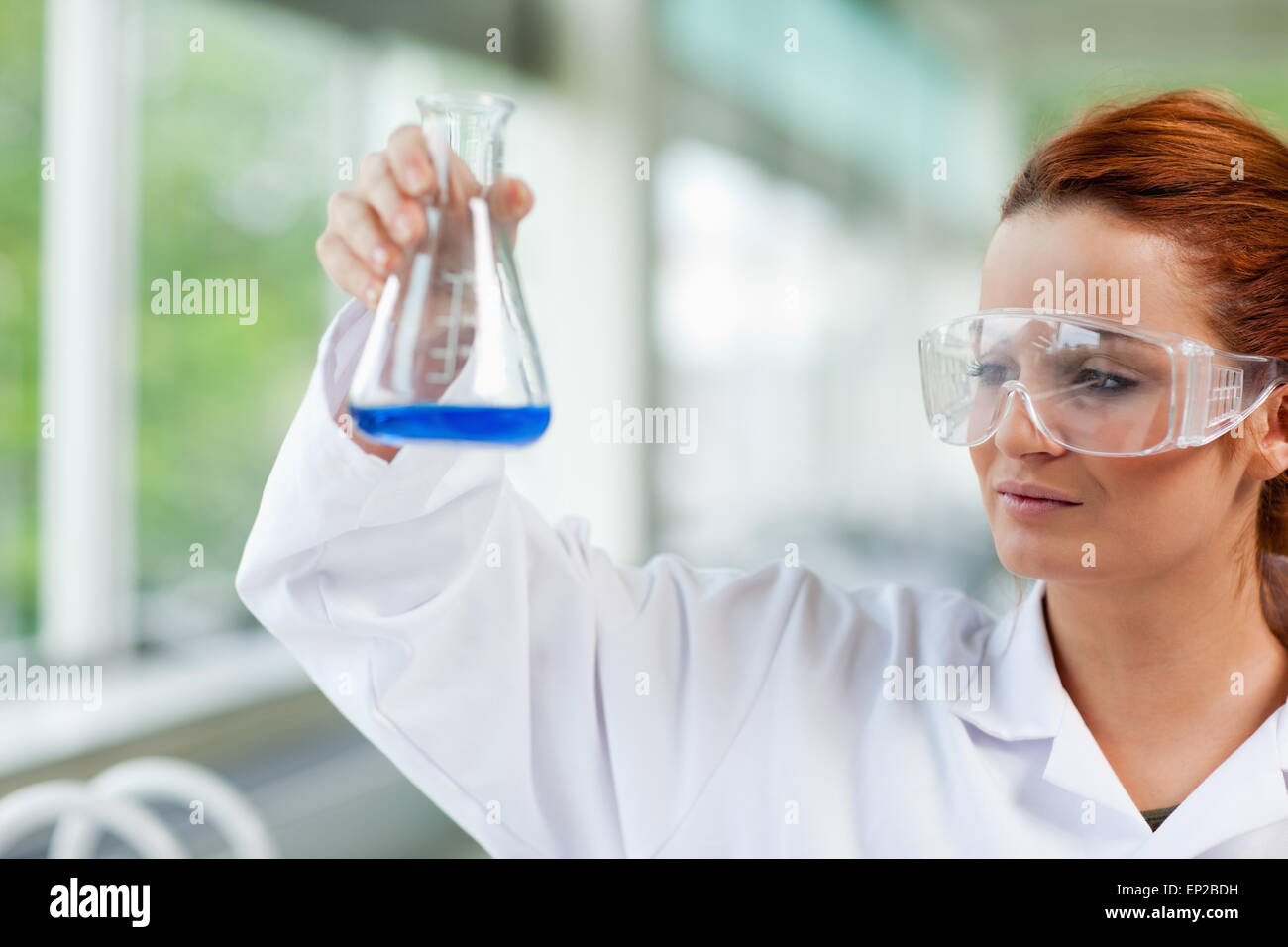 Science student looking at an Erlenmeyr flask Stock Photo - Alamy