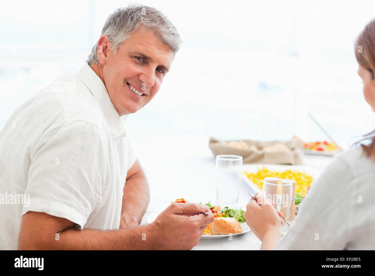 Side view of happy smiling man during dinner Stock Photo - Alamy