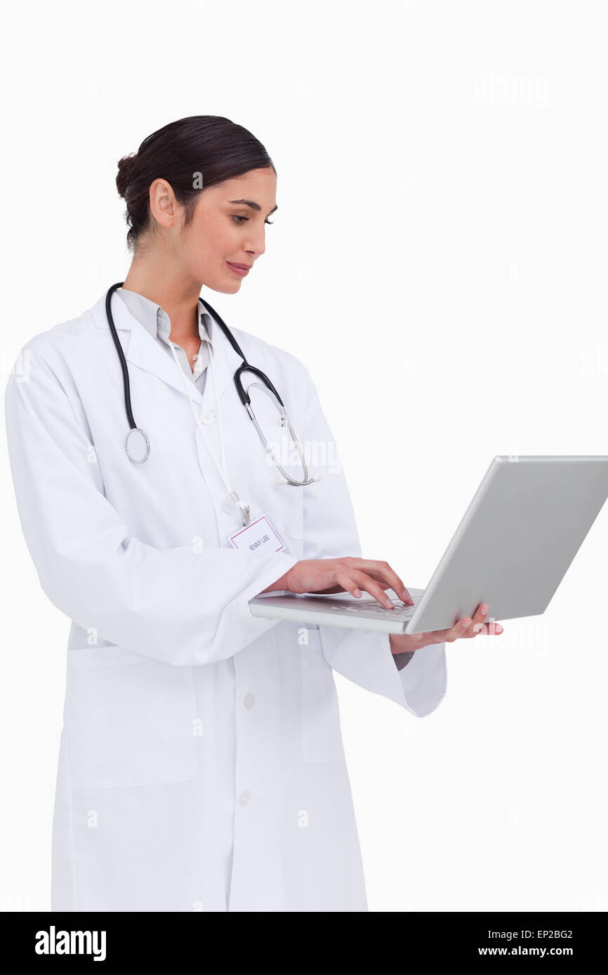 Side view of female doctor working on her laptop Stock Photo - Alamy