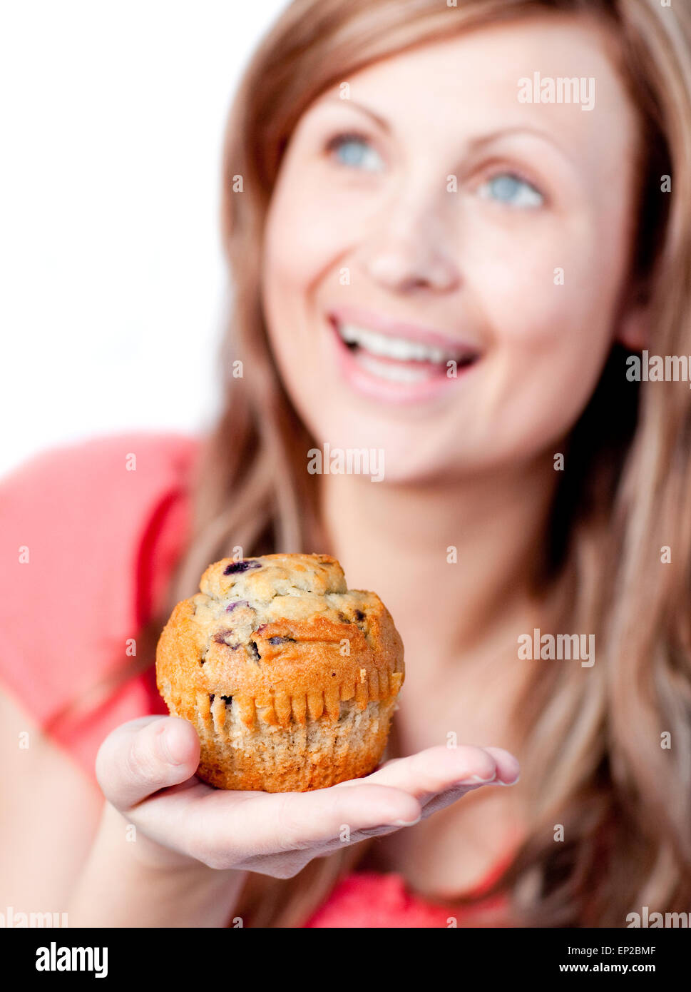 Cute woman is eating a muffin Stock Photo - Alamy