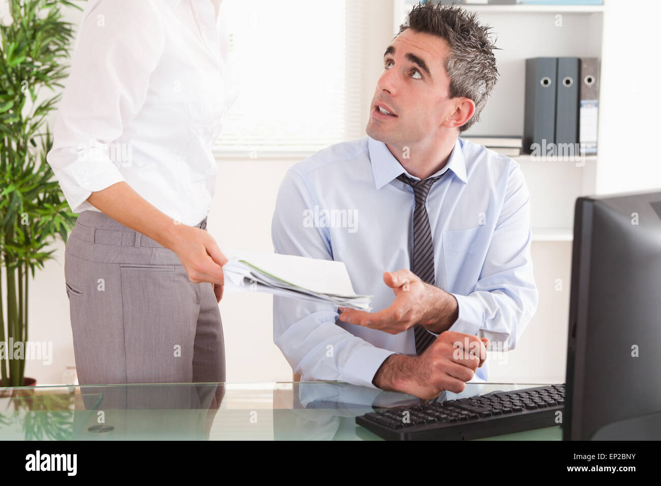 Manager receiving a document from his secretary Stock Photo - Alamy