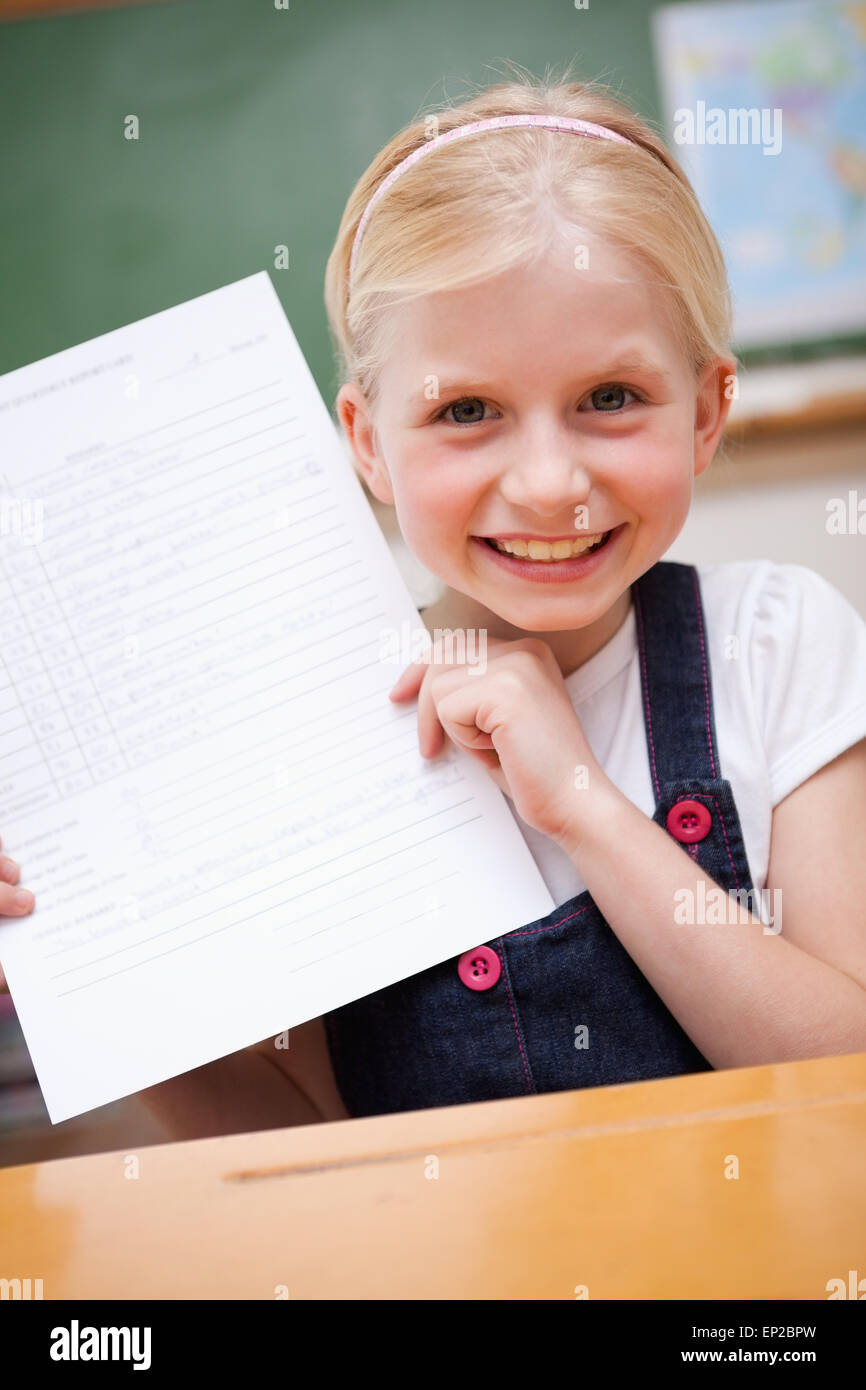 Portrait of a happy girl showing her school report Stock Photo - Alamy