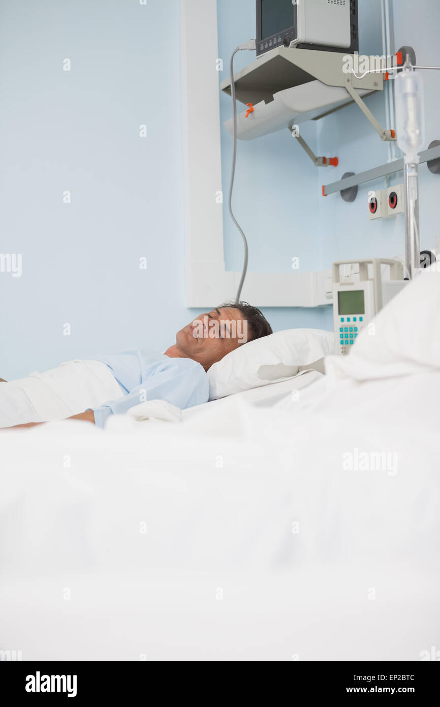 Patient sleeping while lying on a medical bed Stock Photo - Alamy