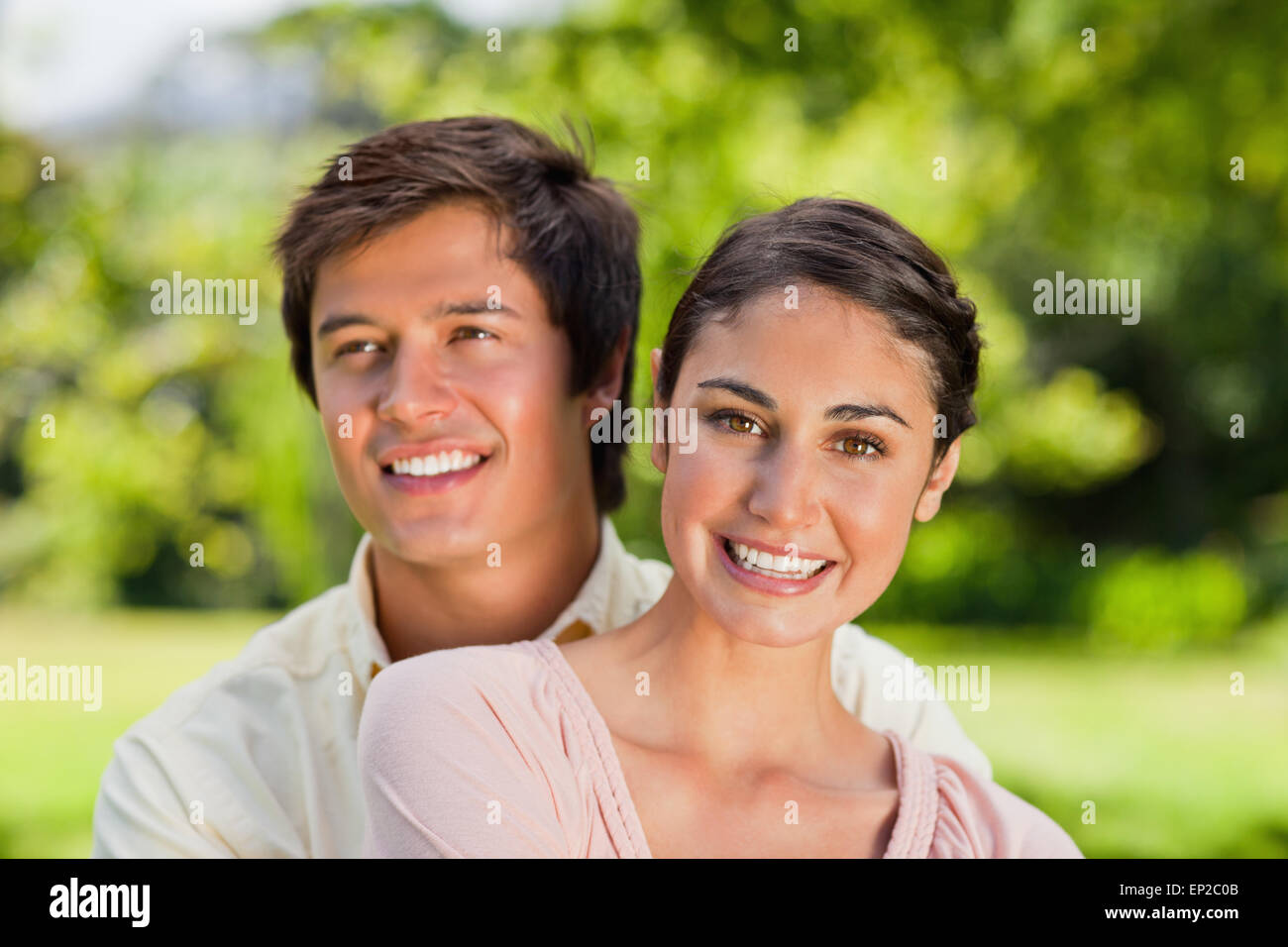 Two friends looking into the distance while holding onto each other ...
