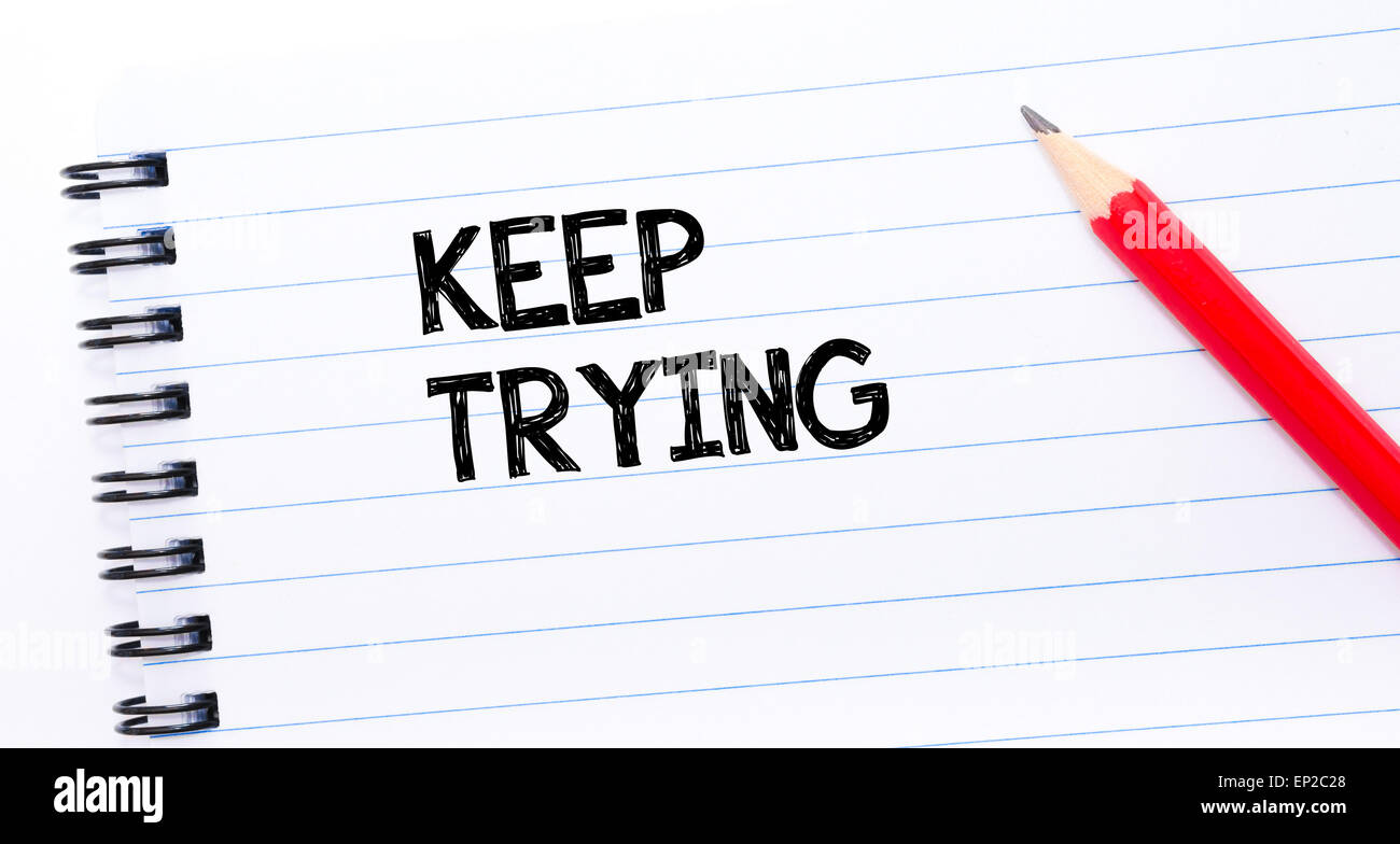 Keep Trying Text written on notebook page, red pencil on the right ...