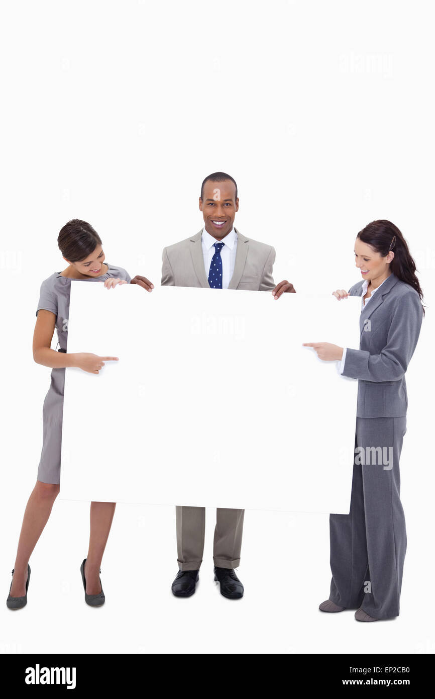 Businesspeople pointing at blank sign in their hands Stock Photo - Alamy