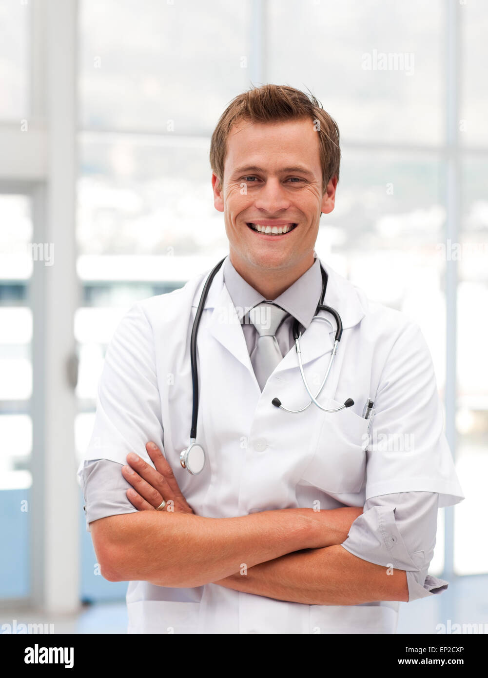 Handsome doctor smiling at camera Stock Photo - Alamy