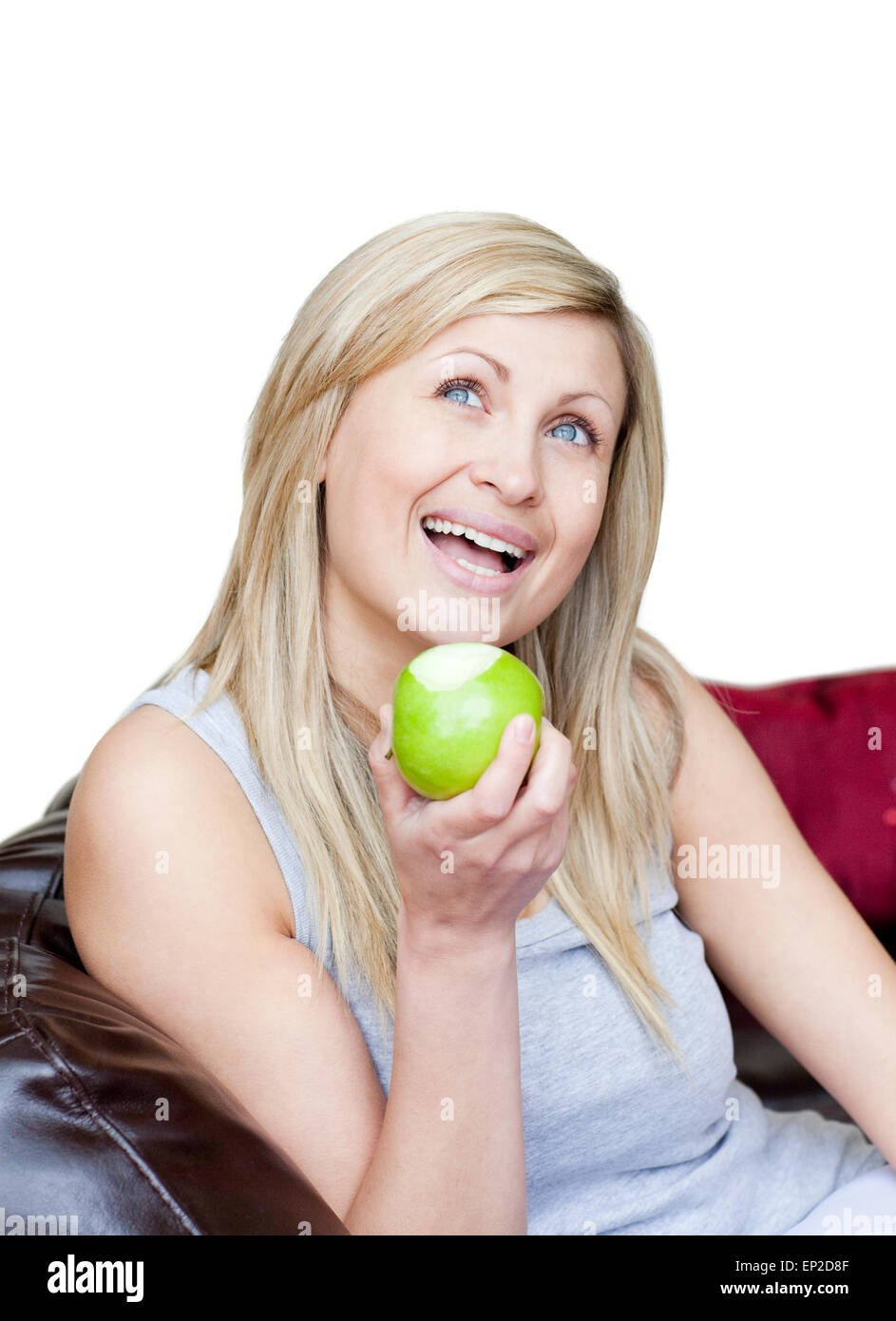 Smiling woman eating an apple against a white background Stock Photo ...