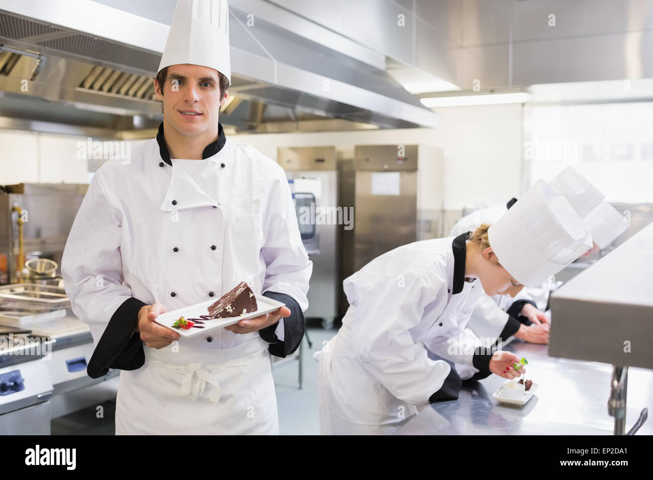 Chef's preparing deserts with one chef presenting his dish Stock Photo ...