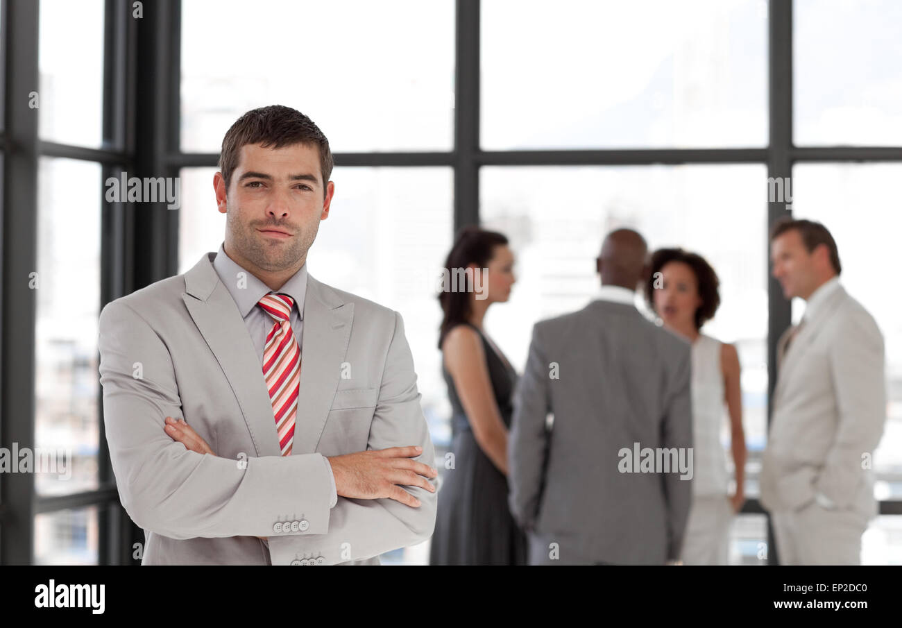 Attractive confident male manager leading his team Stock Photo - Alamy