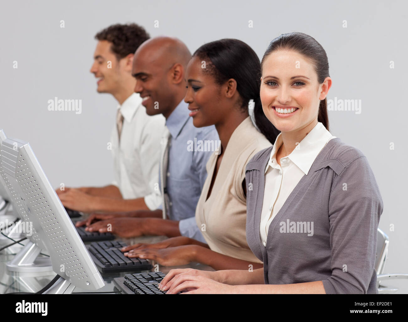 International business people in a line working at computers Stock ...