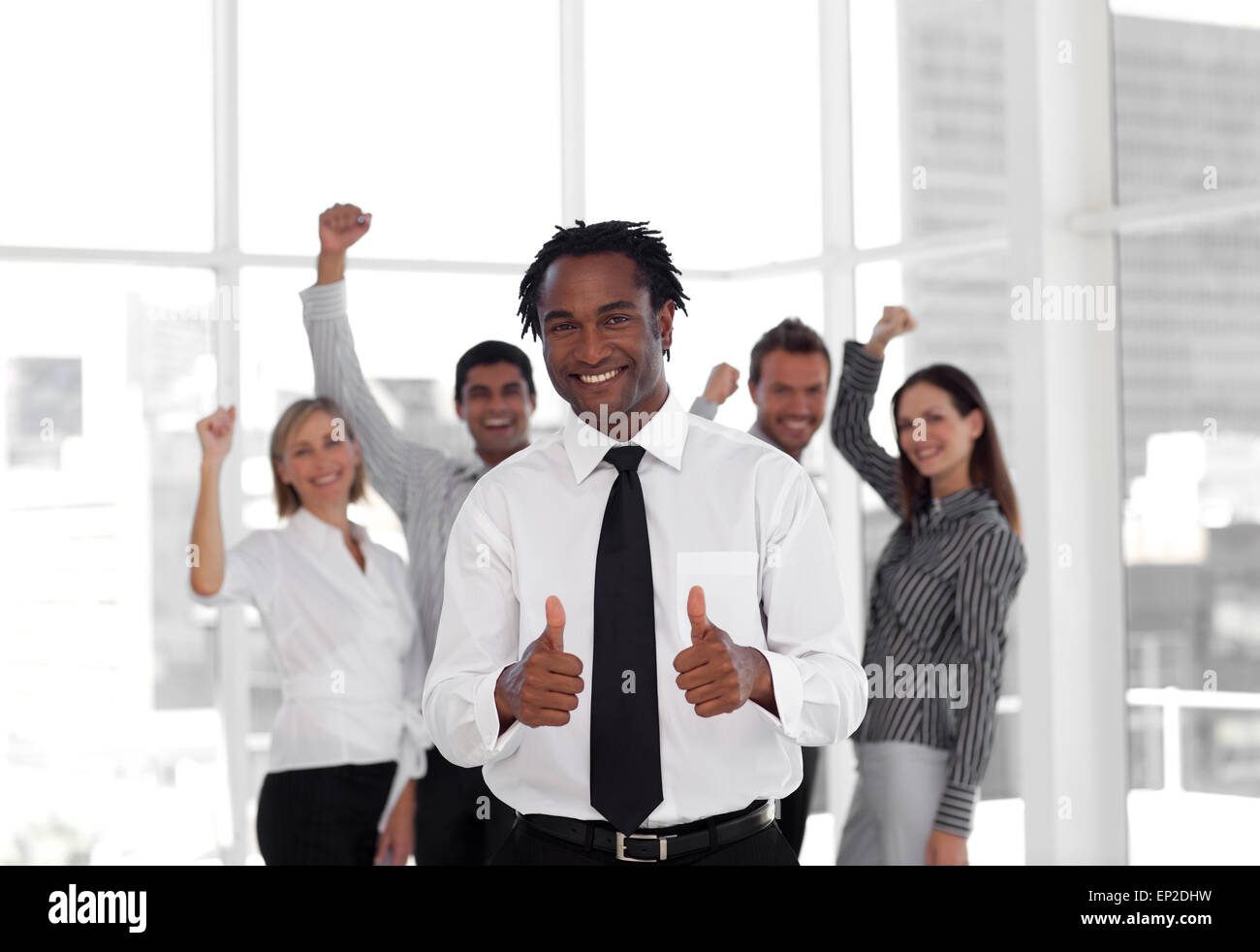 Male manager doing a thumb-up with his team Stock Photo - Alamy