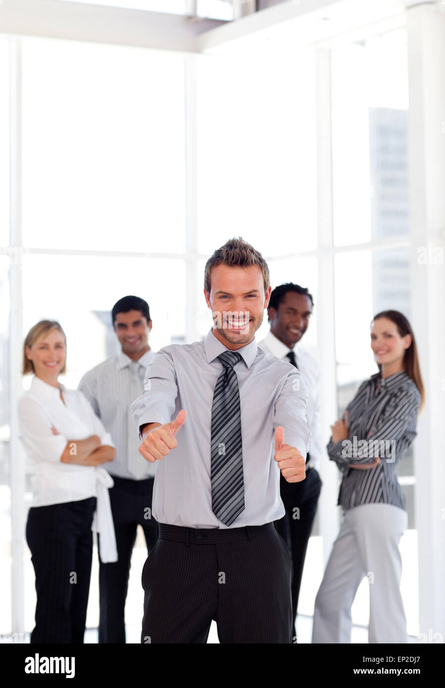 positive business manager standing at the camera with his team Stock ...