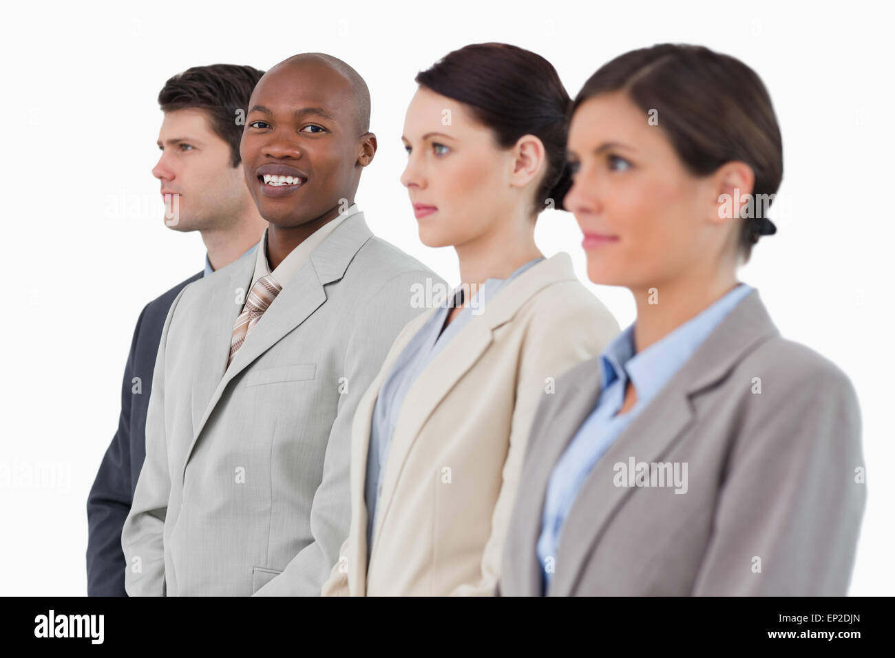 Smiling salesman standing between his associates Stock Photo - Alamy