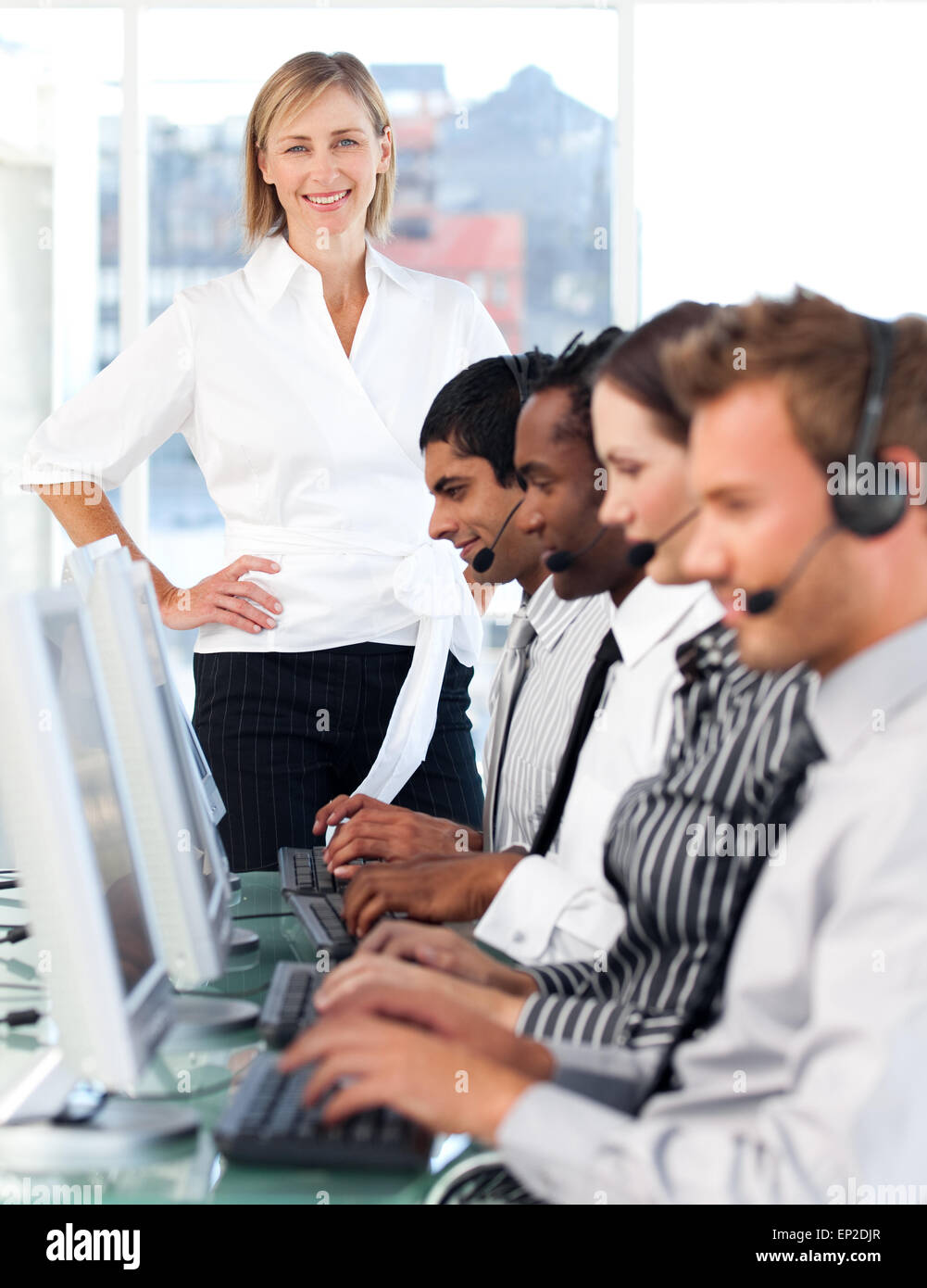 Smiling female manager leading her representative team Stock Photo - Alamy