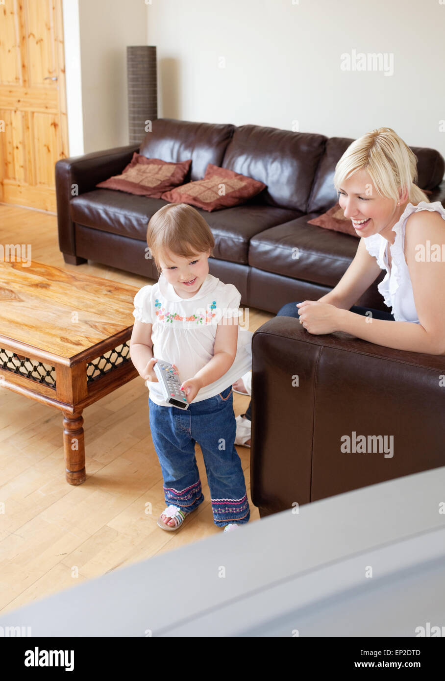 Laughing family in the living room Stock Photo - Alamy