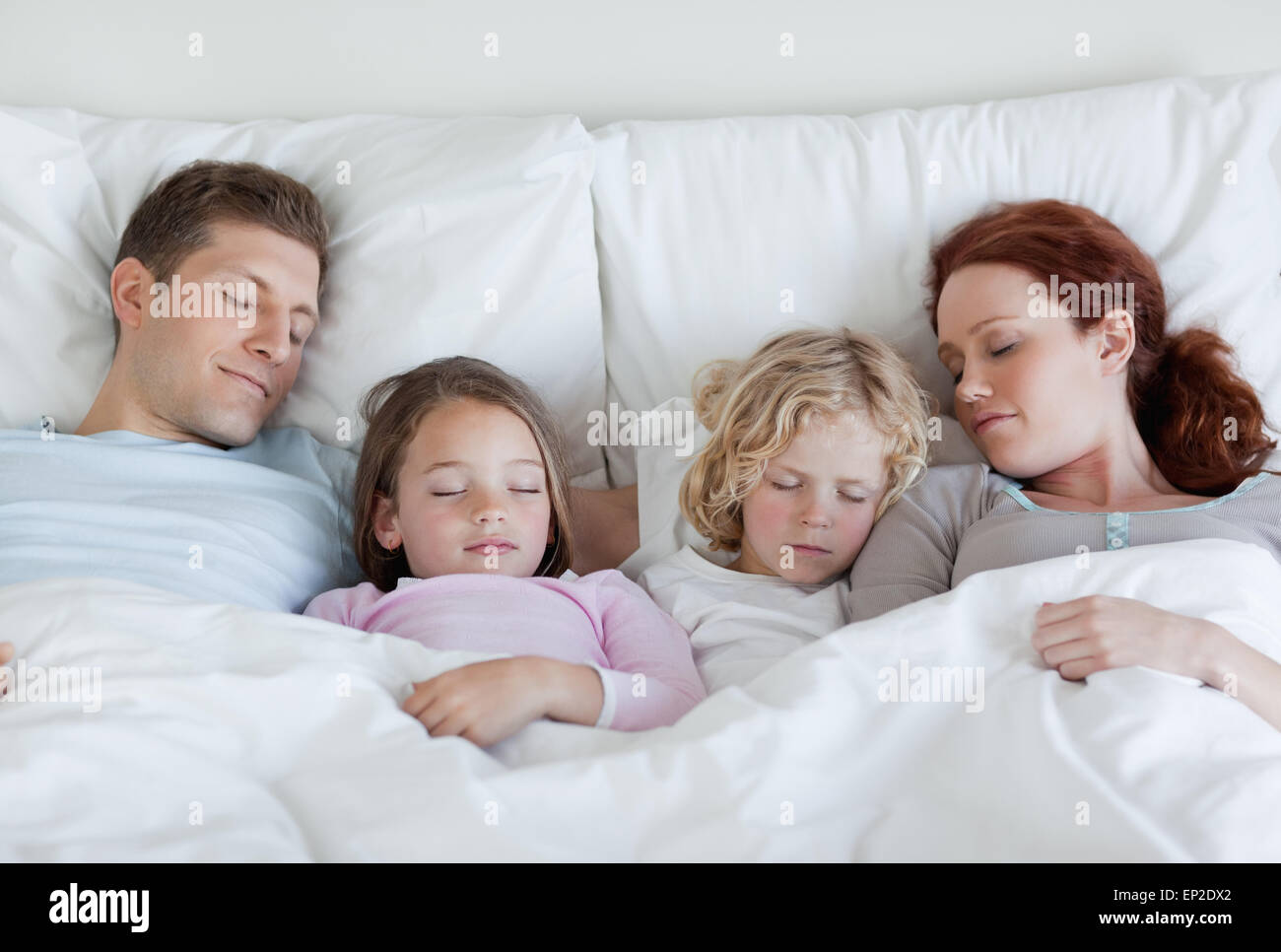 Family taking a nap together Stock Photo - Alamy