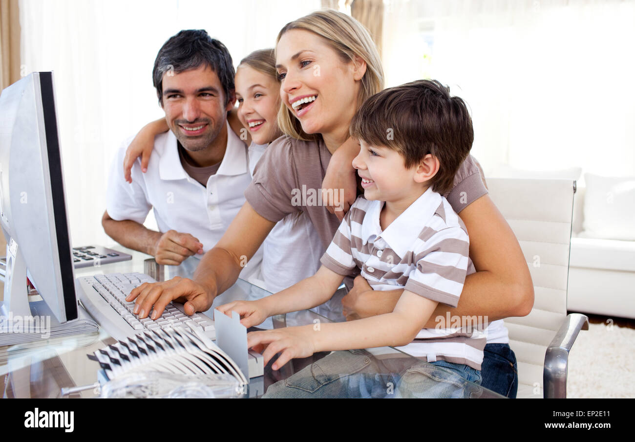 Caring parents teaching their children how to use a computer Stock ...
