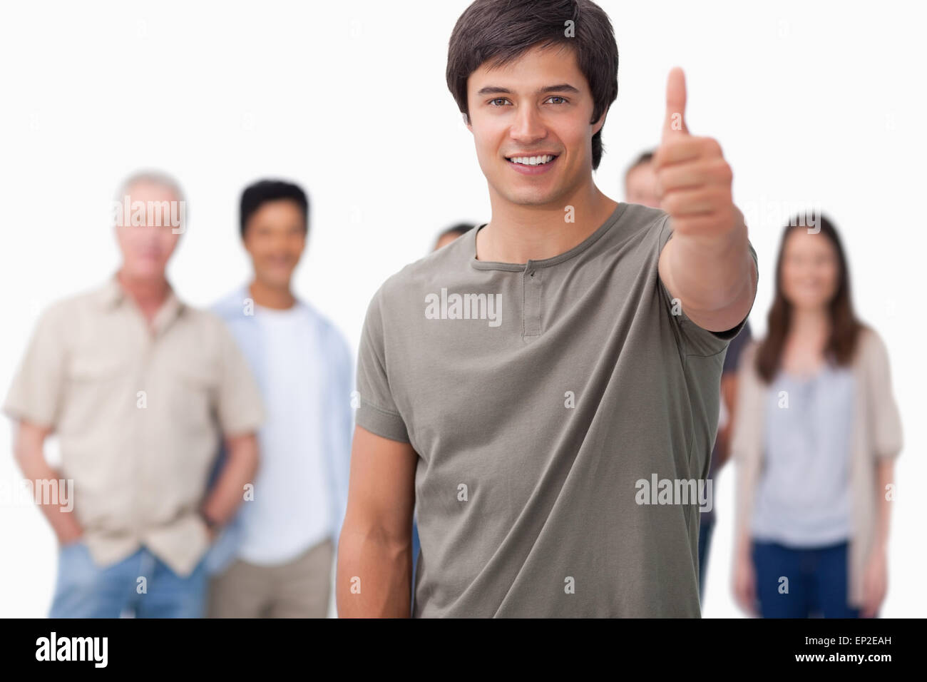 Smiling man with friends behind him giving approval Stock Photo - Alamy