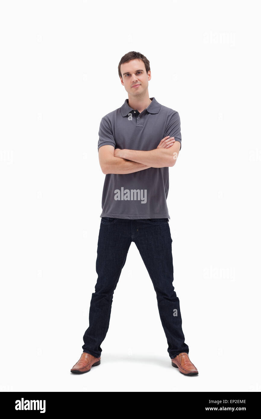 Standing man crossing his arms and his legs apart Stock Photo - Alamy