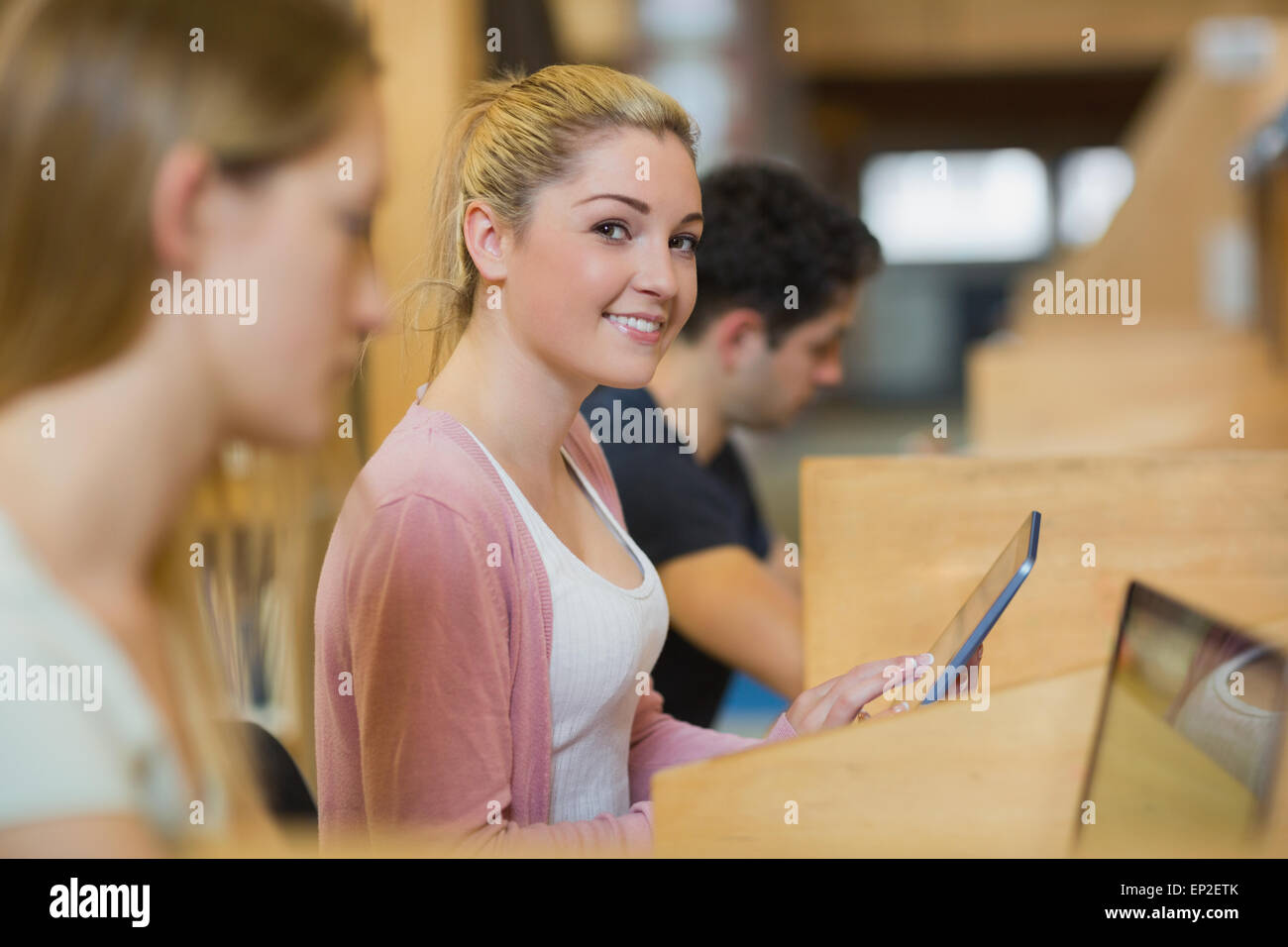 Student with tablet pc looking up from studying Stock Photo - Alamy