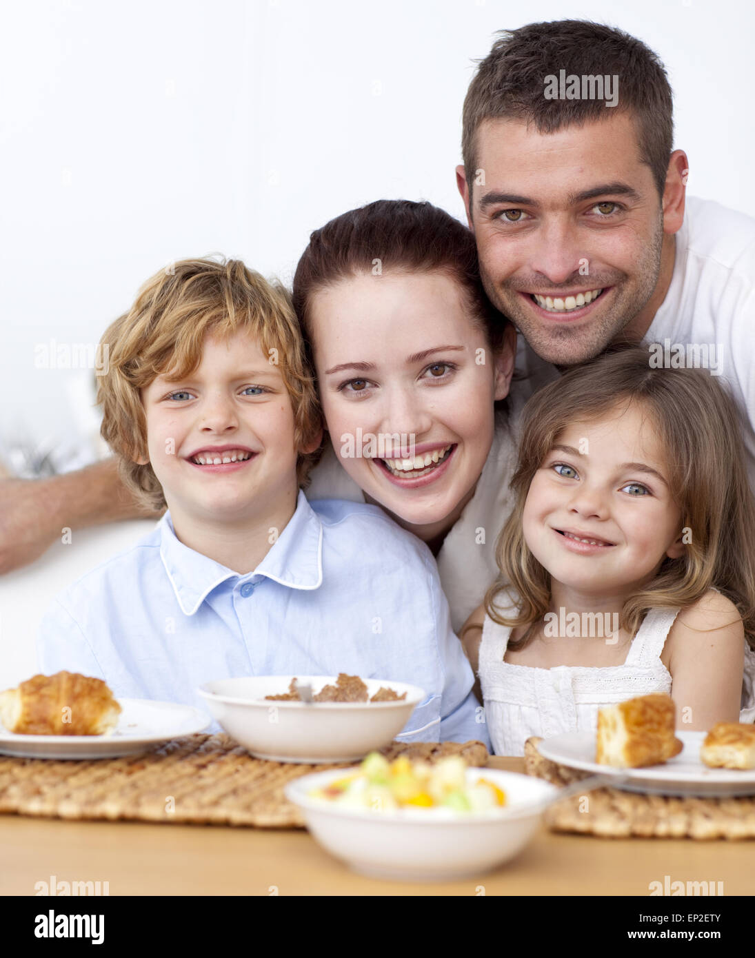 Portrait of happy family having breakfast Stock Photo - Alamy