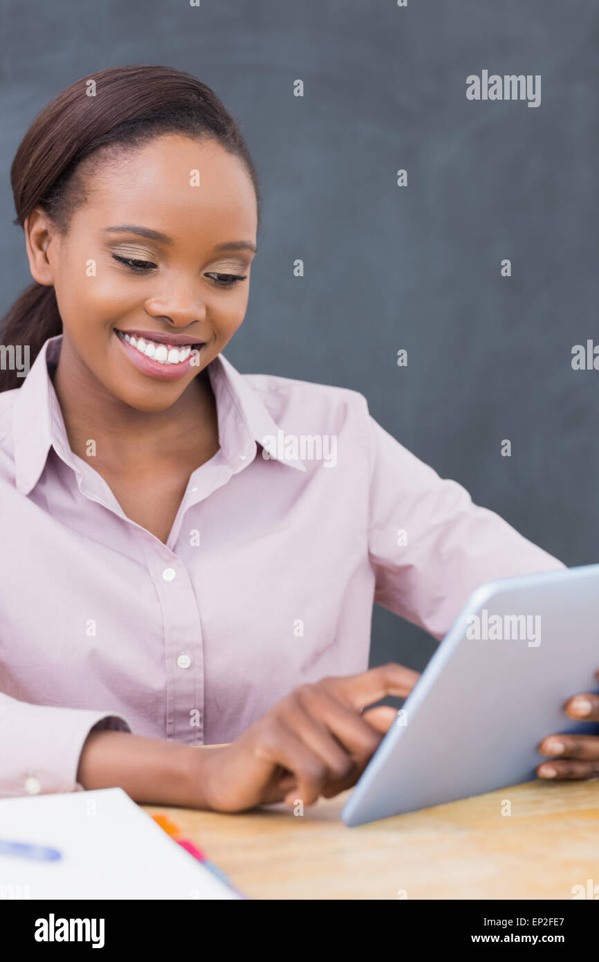 Teacher smiling while using a tablet computer Stock Photo - Alamy